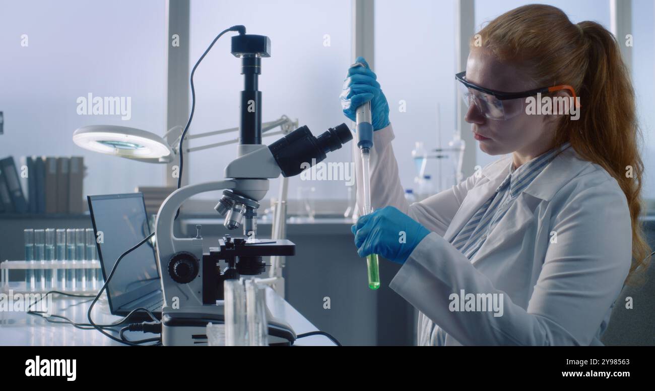 Bright medical science laboratory: Female microbiologist looks under ...