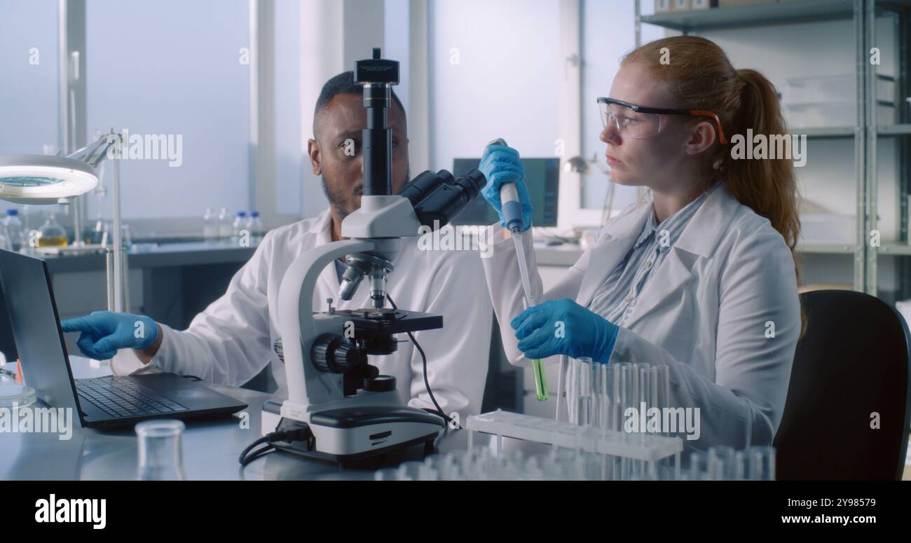 Diverse team of professional microbiologists developing vaccine, doing ...