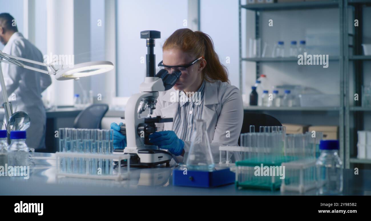 Medical science lab: Female microbiologist takes liquid from test tube ...