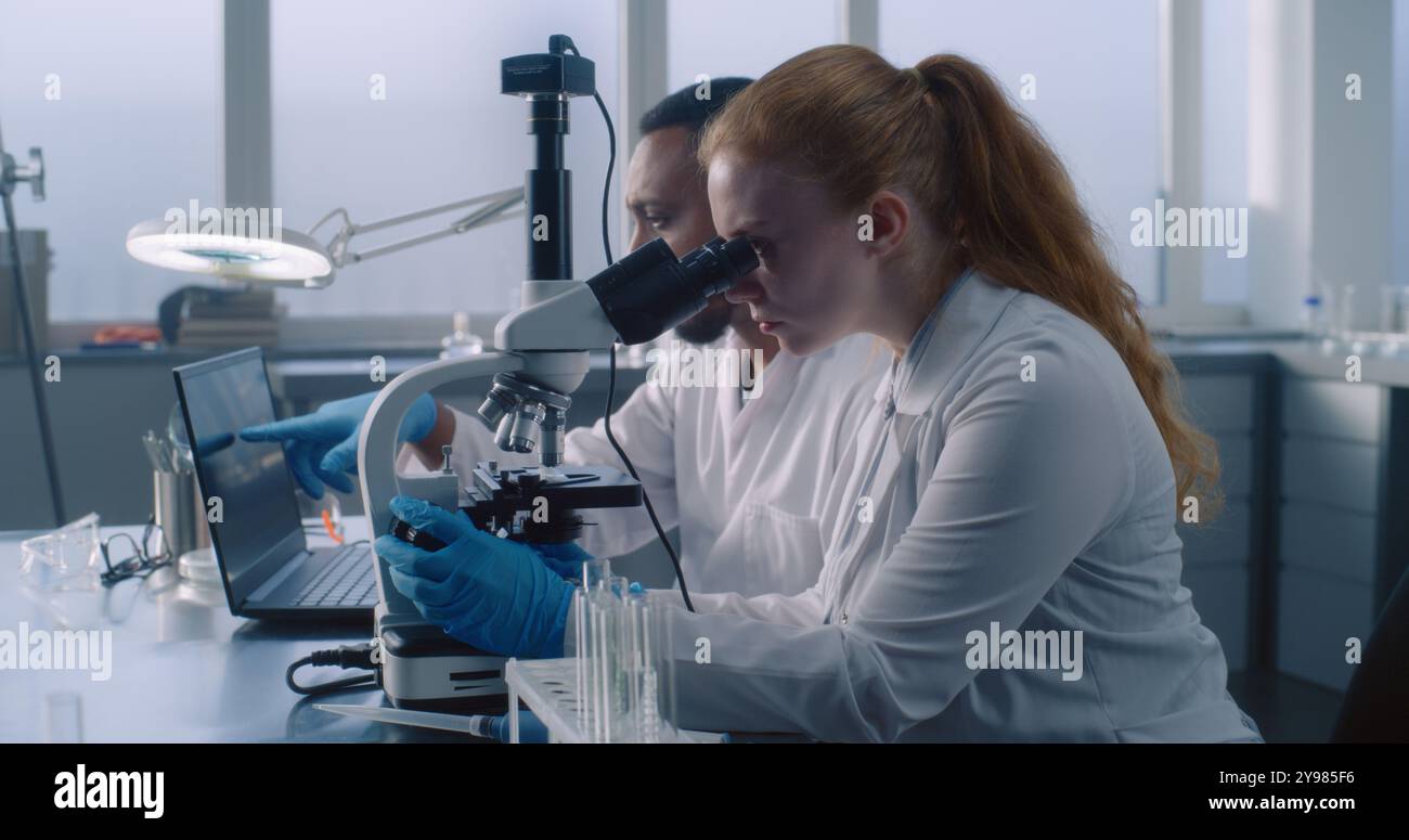 Diverse team of professional microbiologists developing vaccine, doing ...