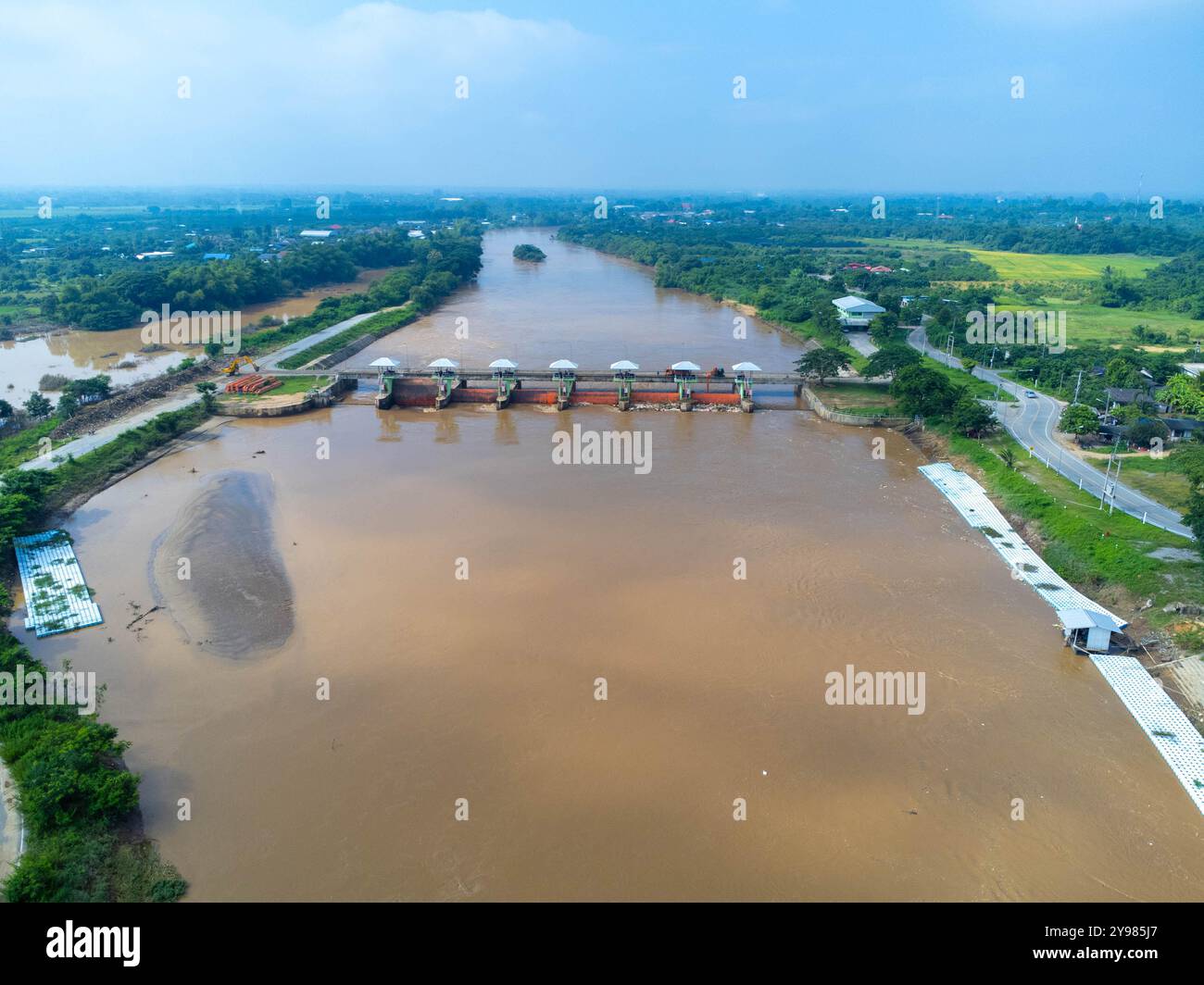 Aerial view of the dam's floodgates with rapid flow of water in the ...