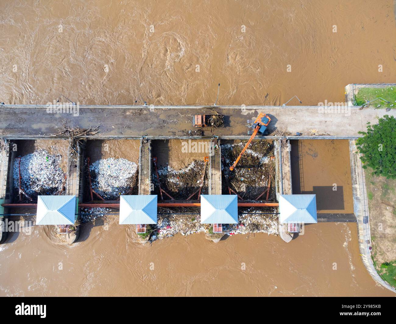 Aerial view of the dam's floodgates with rapid flow of water in the ...