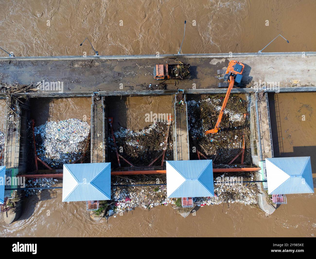 Aerial view of the dam's floodgates with rapid flow of water in the ...