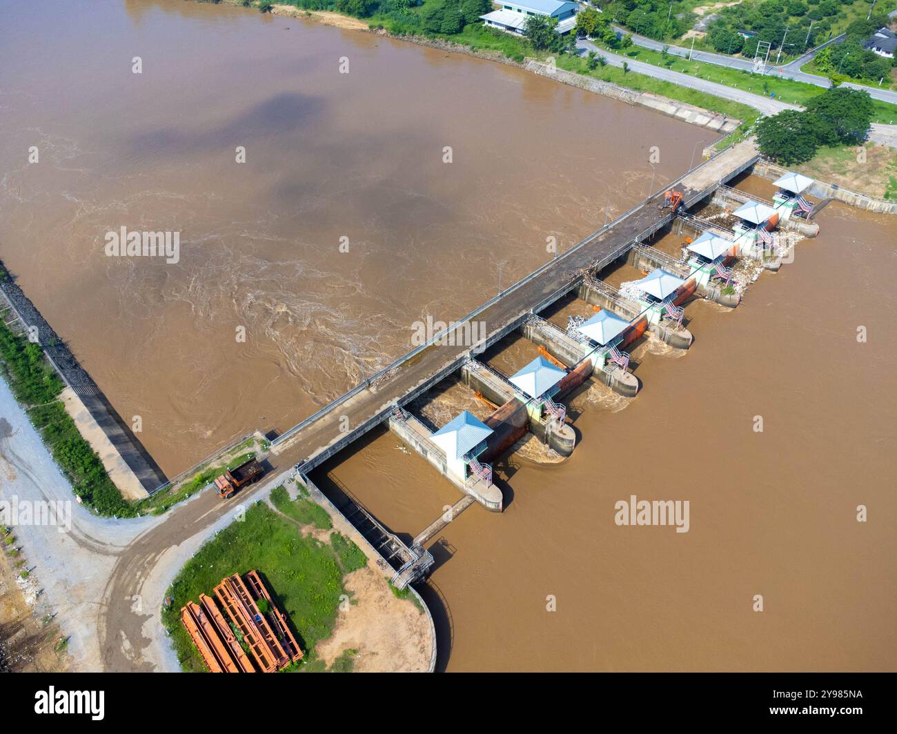 Aerial view of the dam's floodgates with rapid flow of water in the ...