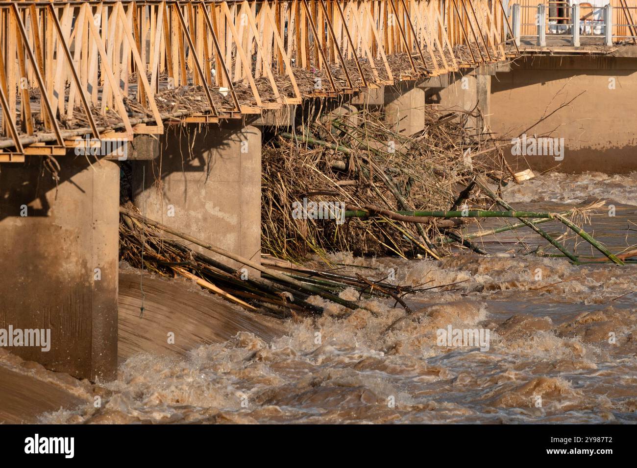 Debris from the violent flash floods stuck to the bridge Stock Photo ...