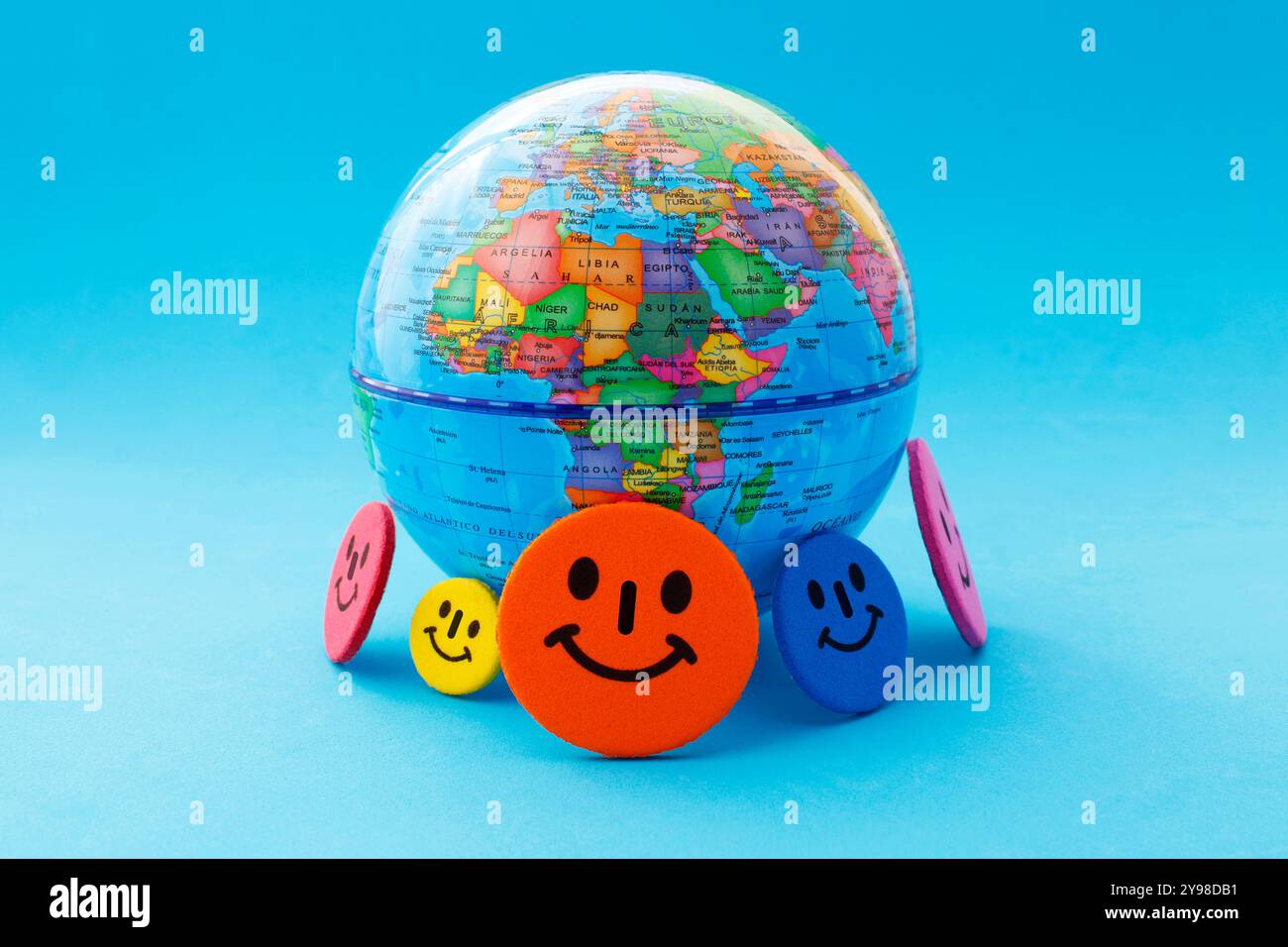 Happy faces surrounding planet Earth Stock Photo - Alamy