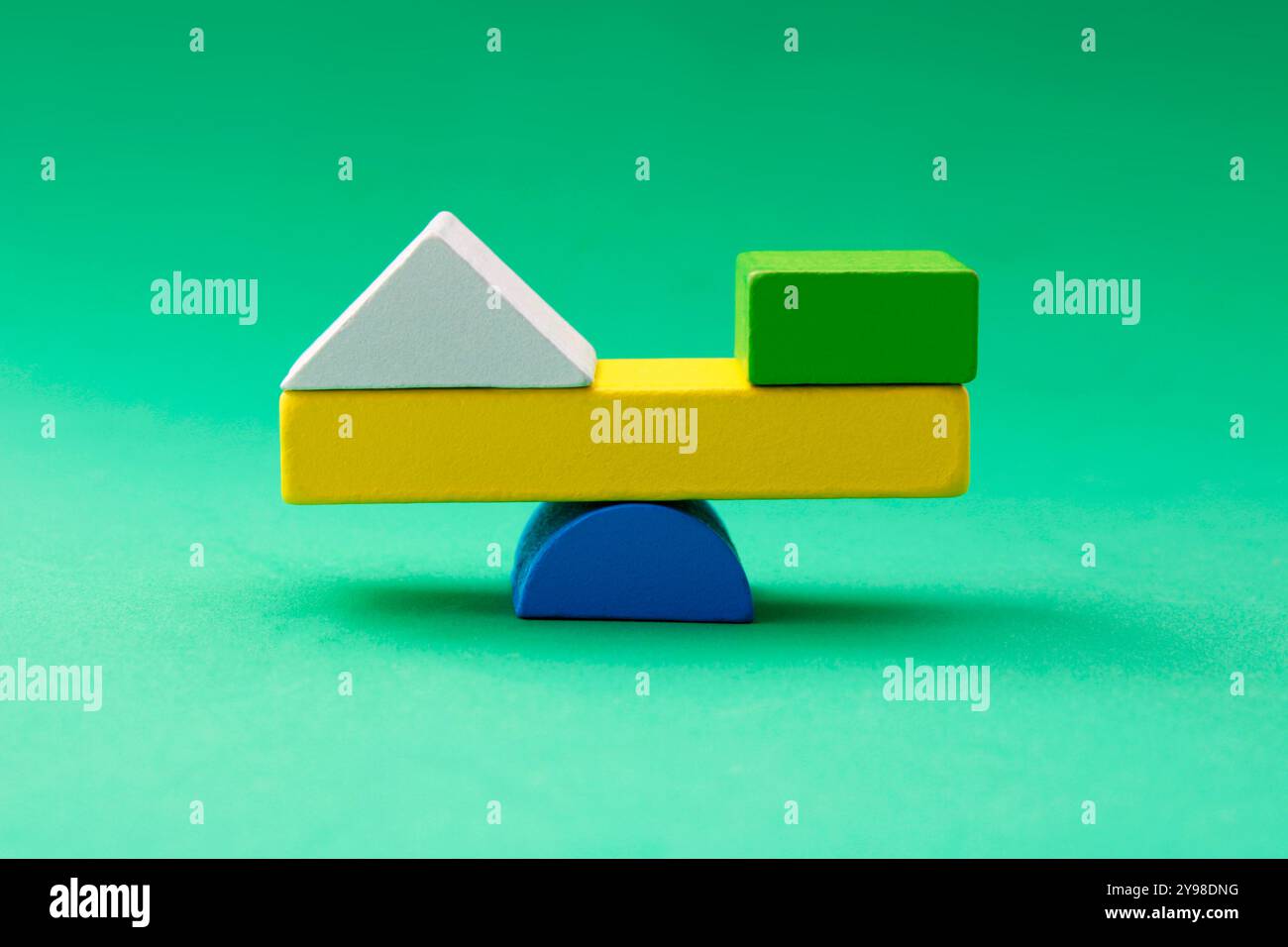 Colorful wooden geometric figures in balance Stock Photo - Alamy