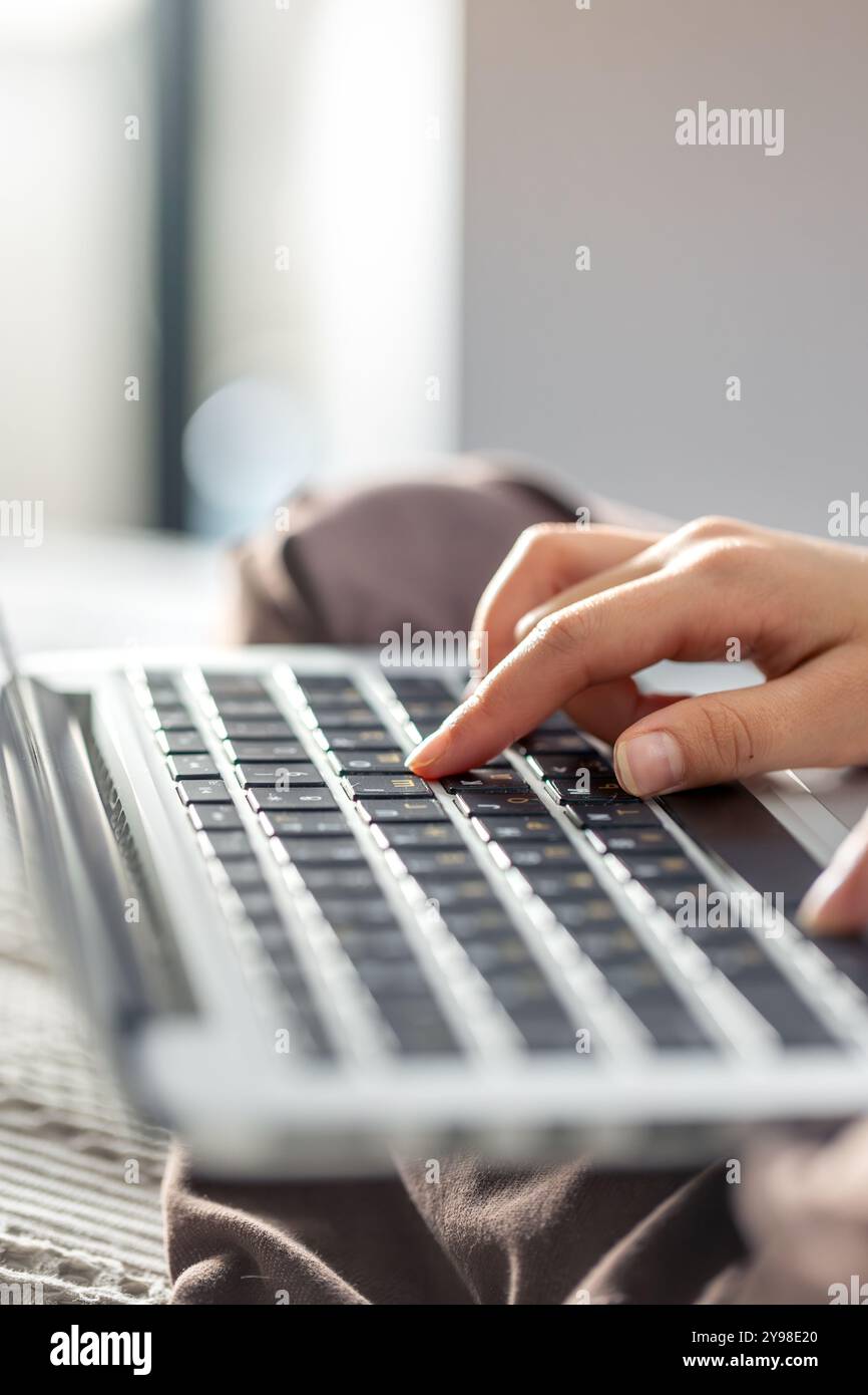 The girl is typing on the laptop keyboard. Girl's hands on the keyboard ...