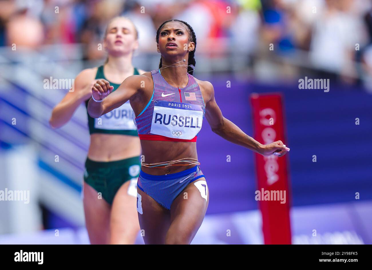 Masai Russell participating in the 100 meters hurdles at the Paris 2024 ...