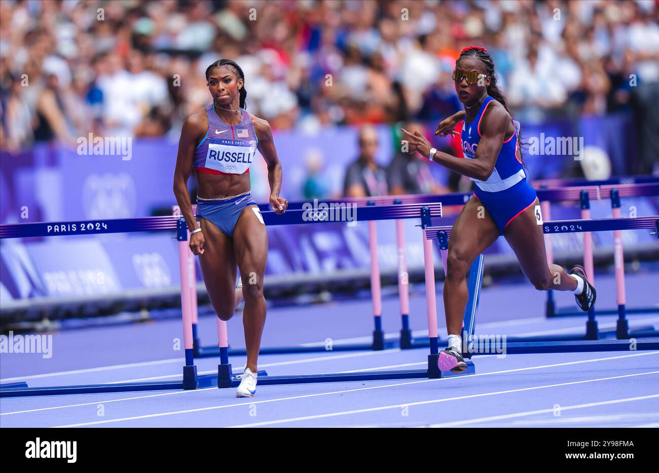 Masai Russell participating in the 100 meters hurdles at the Paris 2024 ...