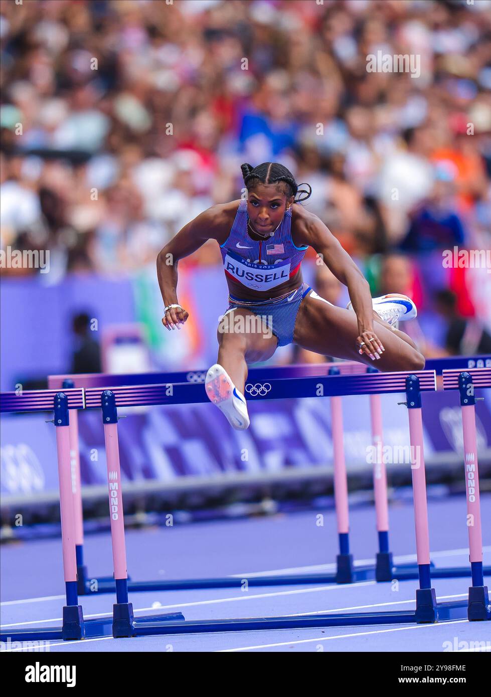 Masai Russell participating in the 100 meters hurdles at the Paris 2024 ...