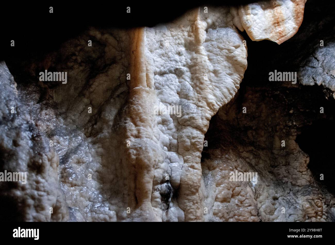 Closeup of limestone formations of stalactites and stalagmites inside a ...