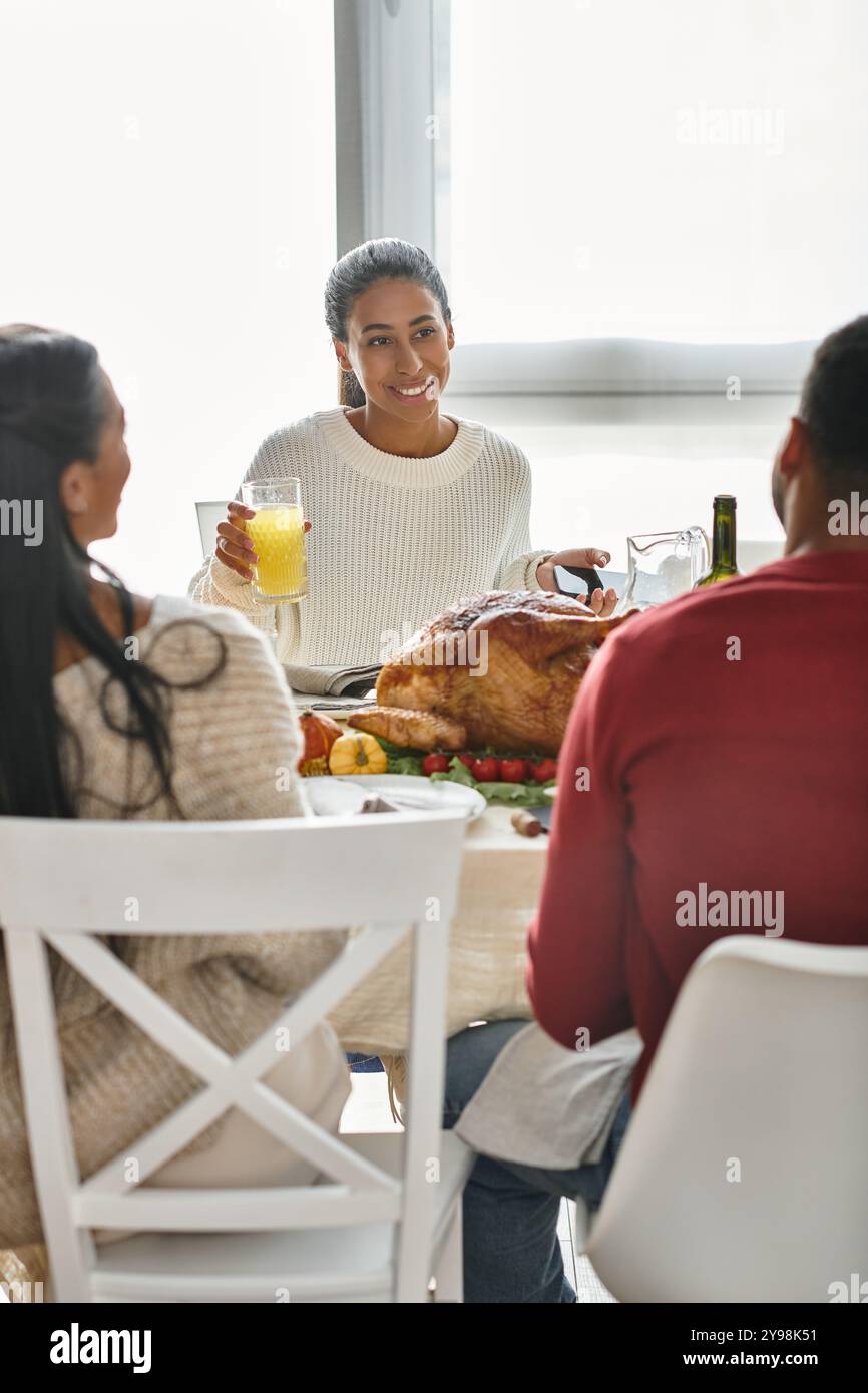 Friends gather around a beautifully set table to savor their ...