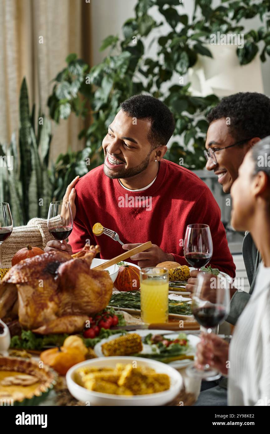 A group of friends joyfully shares a Thanksgiving meal filled with ...