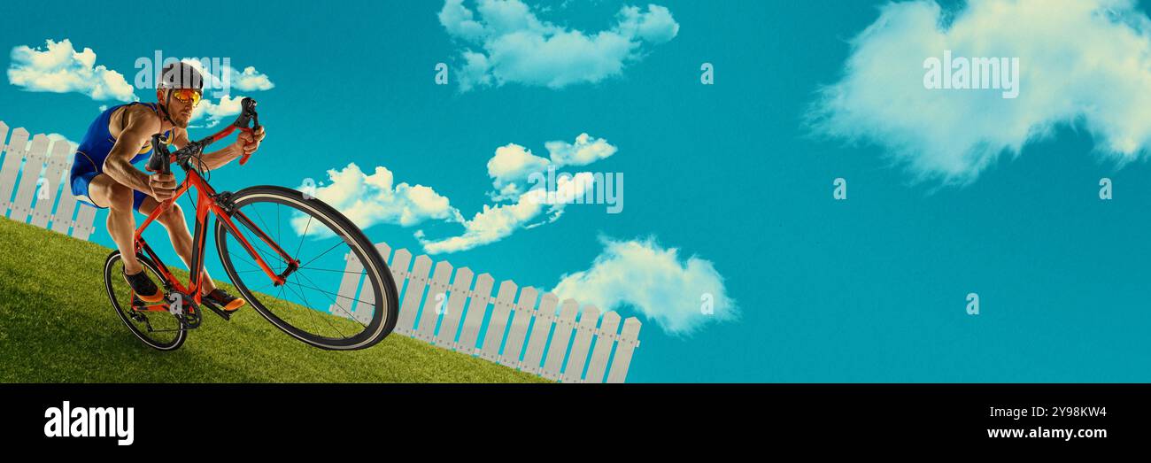 Cyclist leaning into sharp turn on grassy slope, against backdrop of ...