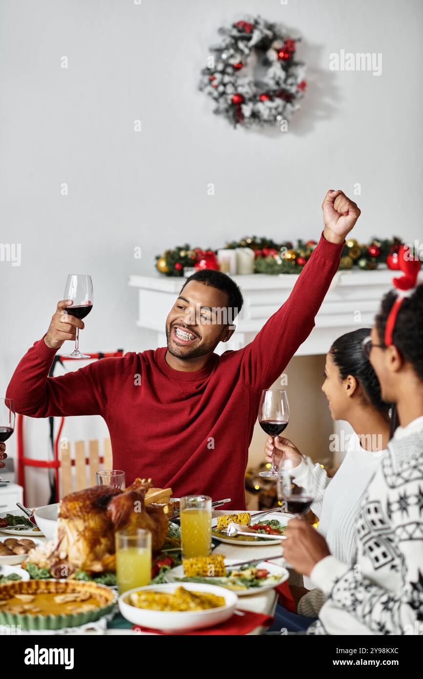 Friends share laughter and toast with drinks while enjoying a festive ...