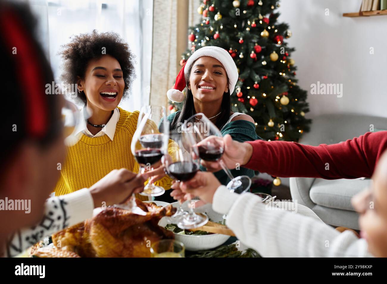 Friends celebrate Christmas together at home, sharing laughter, toasts ...