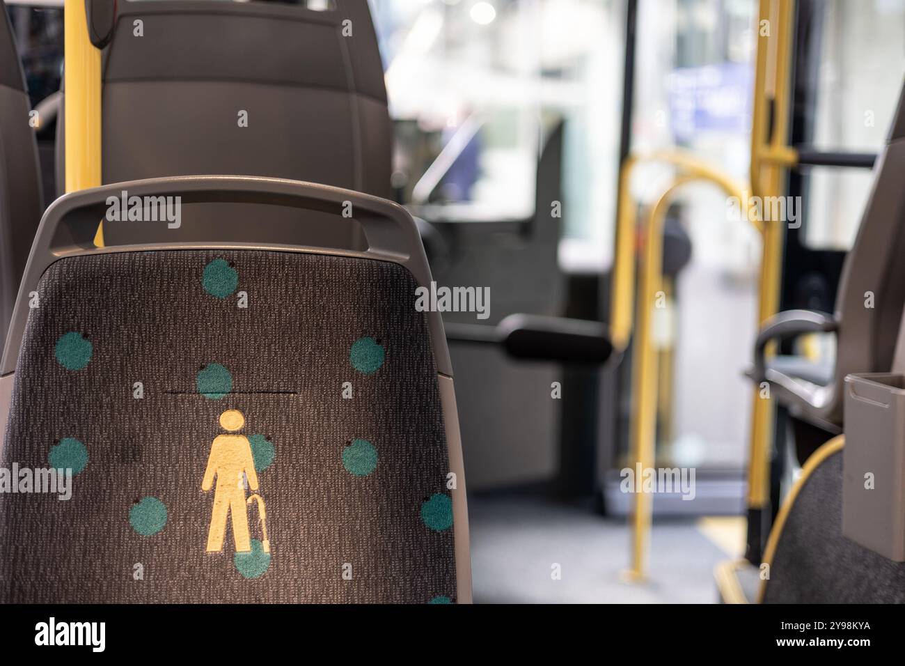 The interior of a city bus shows rows of seats with clear markings for ...