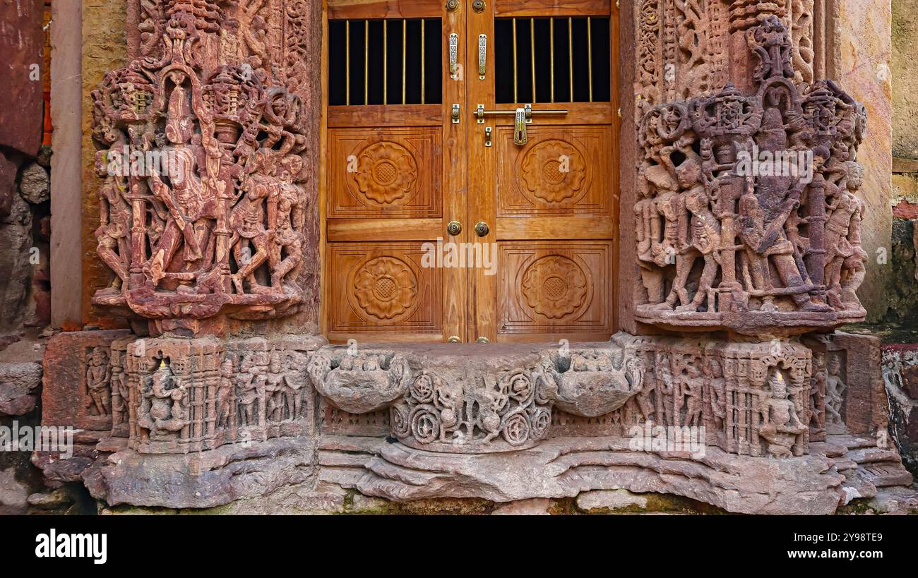Carvings of Hindu deities and Dwarapalas on the entrance of the sanctum ...