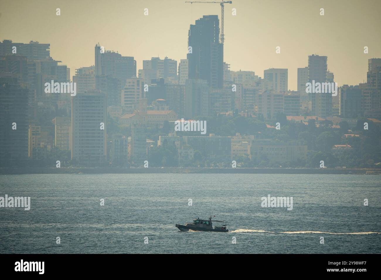 A Lebanese Navy boat navigates by the coast of the city of Beirut, seen ...