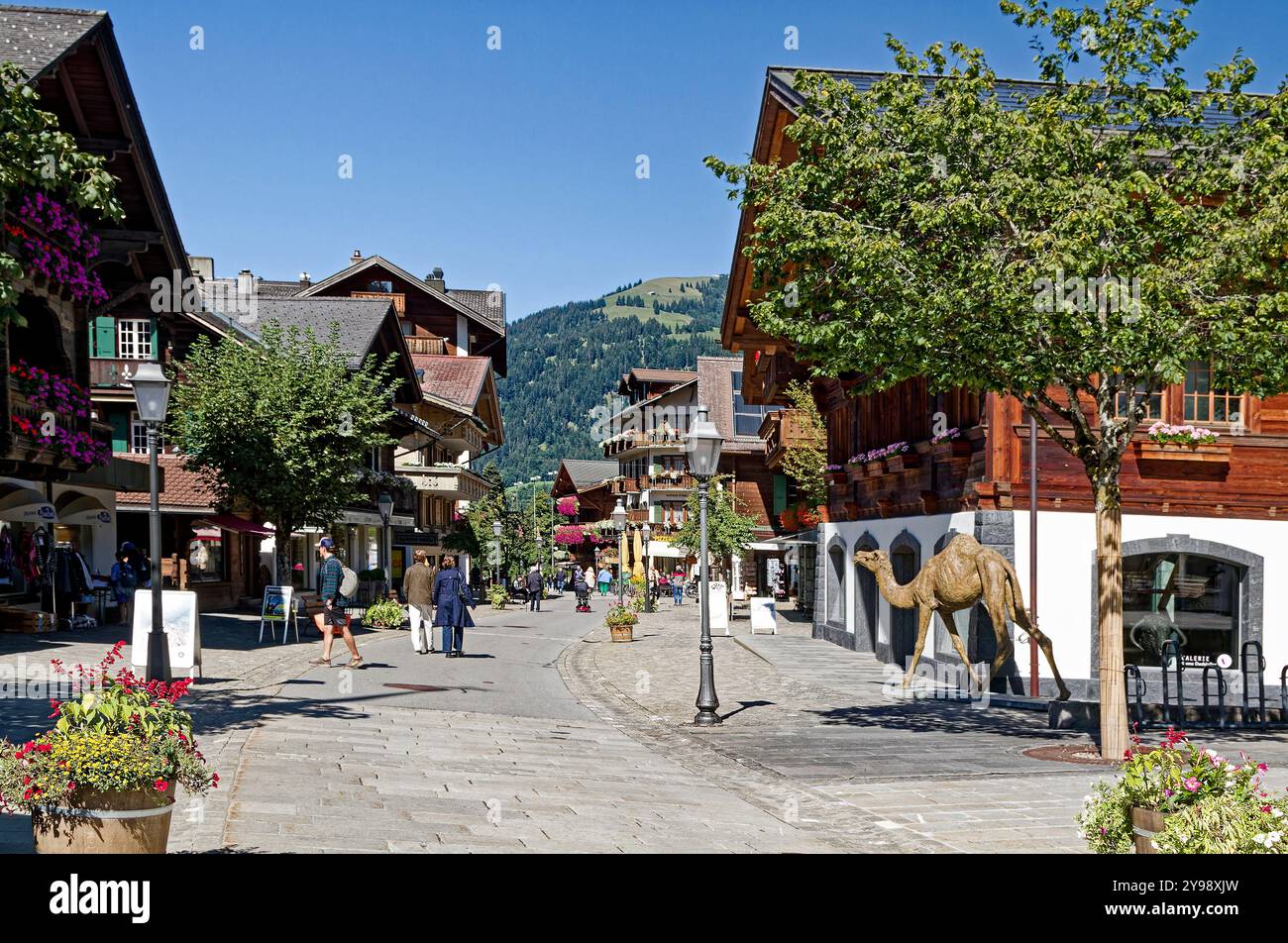 street scene, Gstaad Promenade, Swiss style buildings, shops, people ...