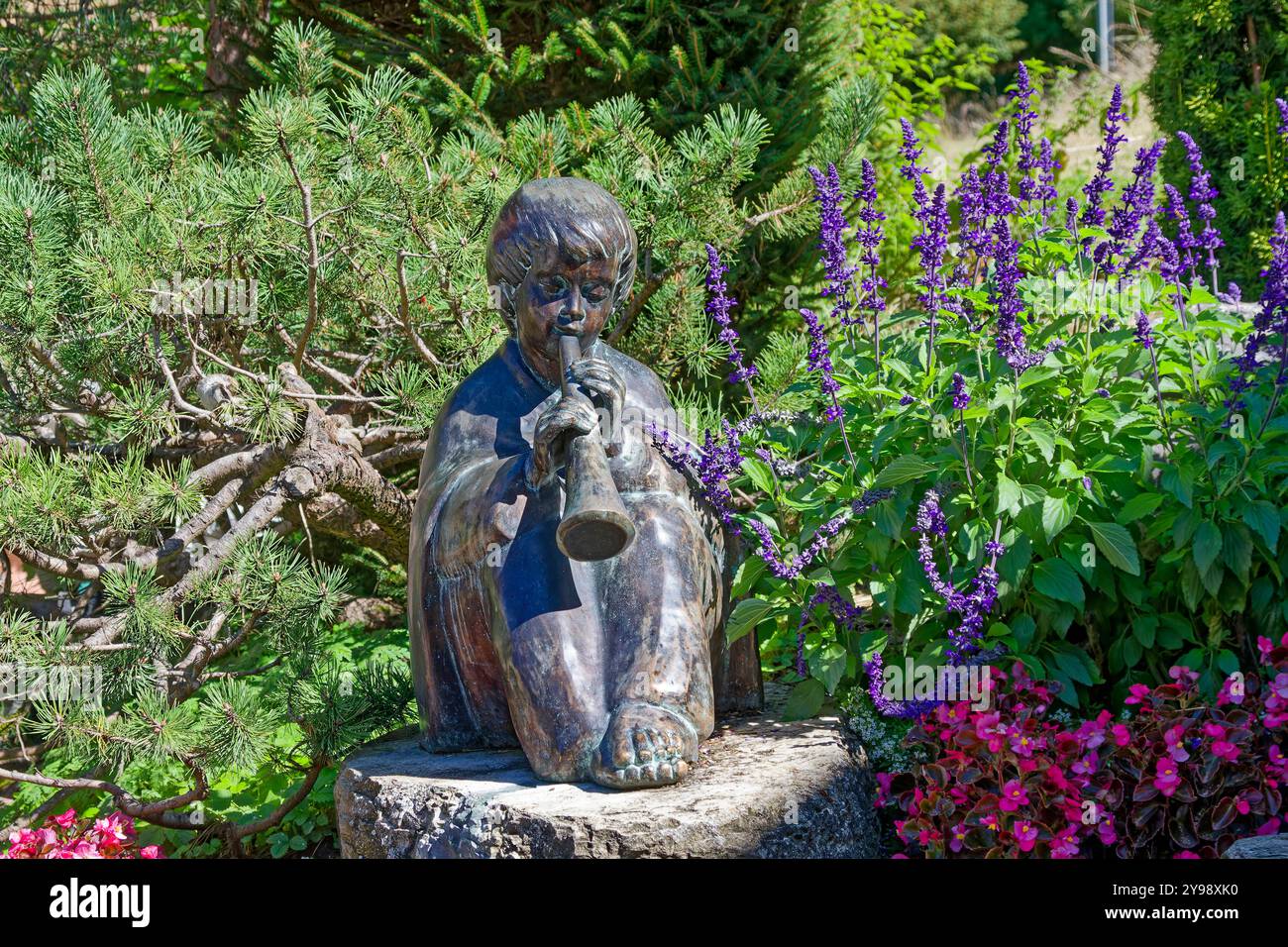child playing horn statue, flowers, green shrubs, public art, Swiss ...
