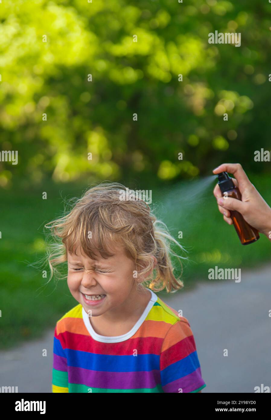 Child spraying mosquito repellent. Selective focus. kid Stock Photo - Alamy