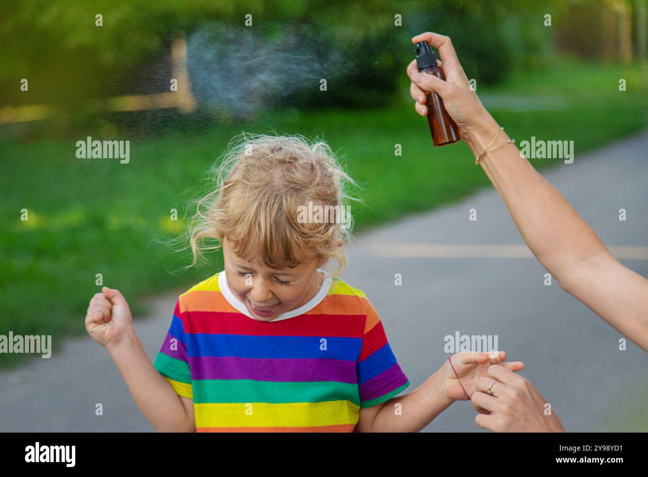 Child spraying mosquito repellent. Selective focus. kid Stock Photo - Alamy