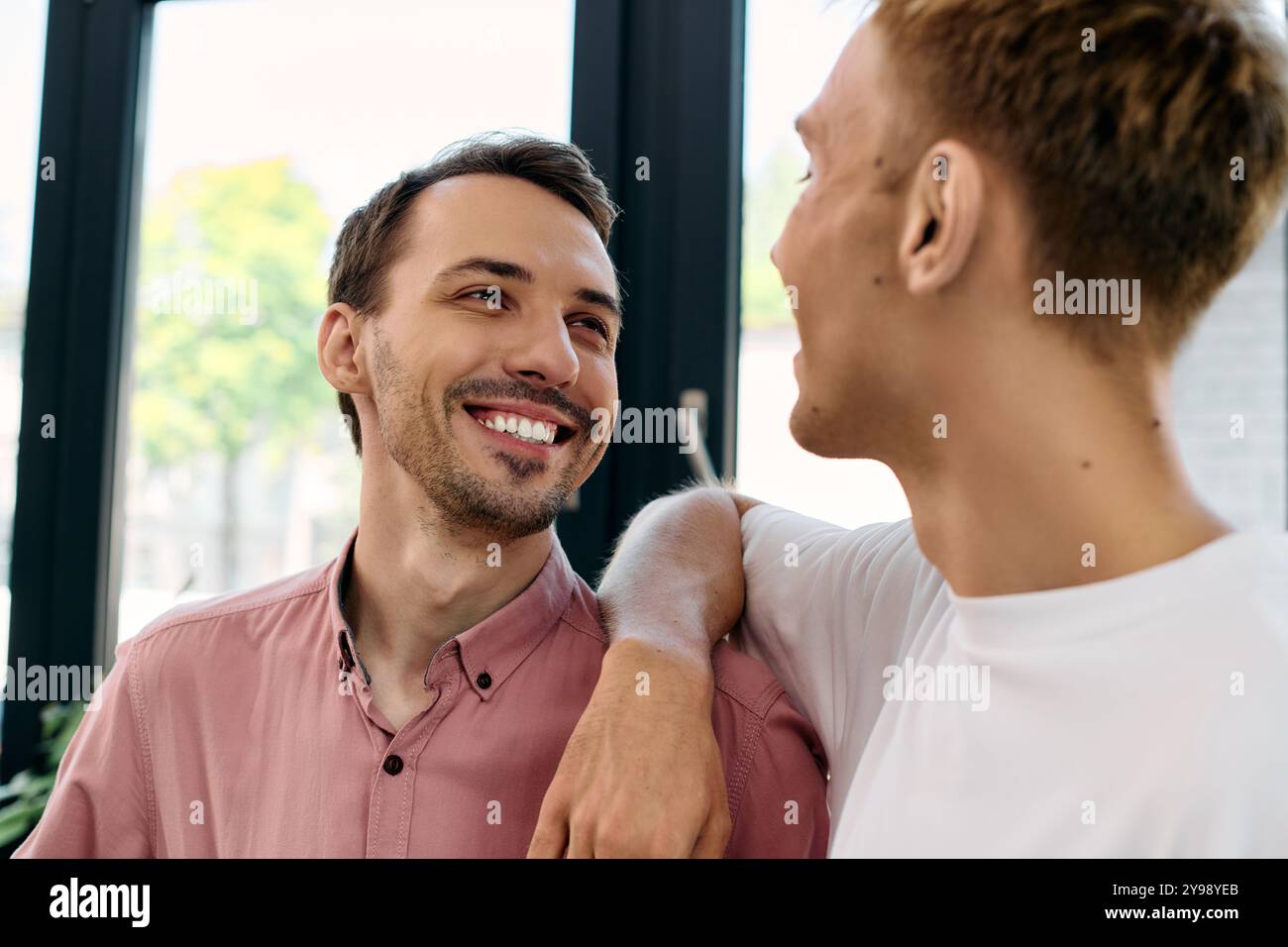 Two handsome men share smiles and laughter while enjoying their time in ...