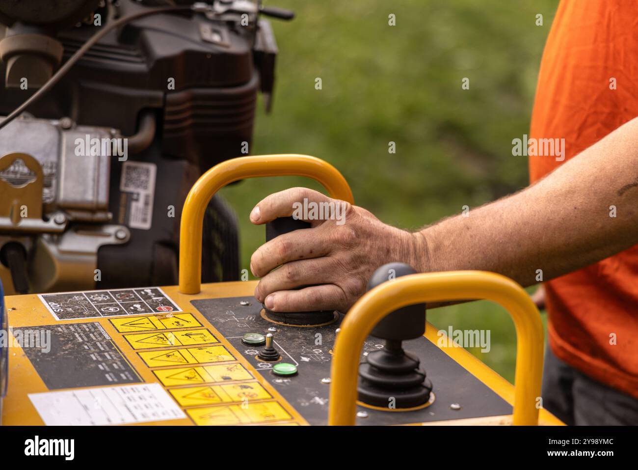Construction worker is operating heavy machinery using a control panel ...