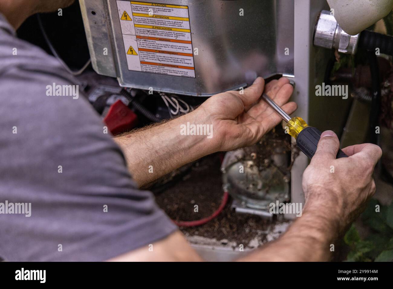Hvac technician is working on the electrical components of a ...