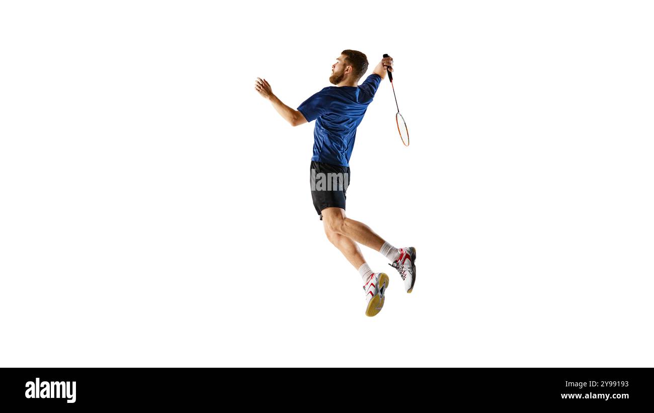 Badminton player leaps mid-air, preparing for powerful strike. His form ...