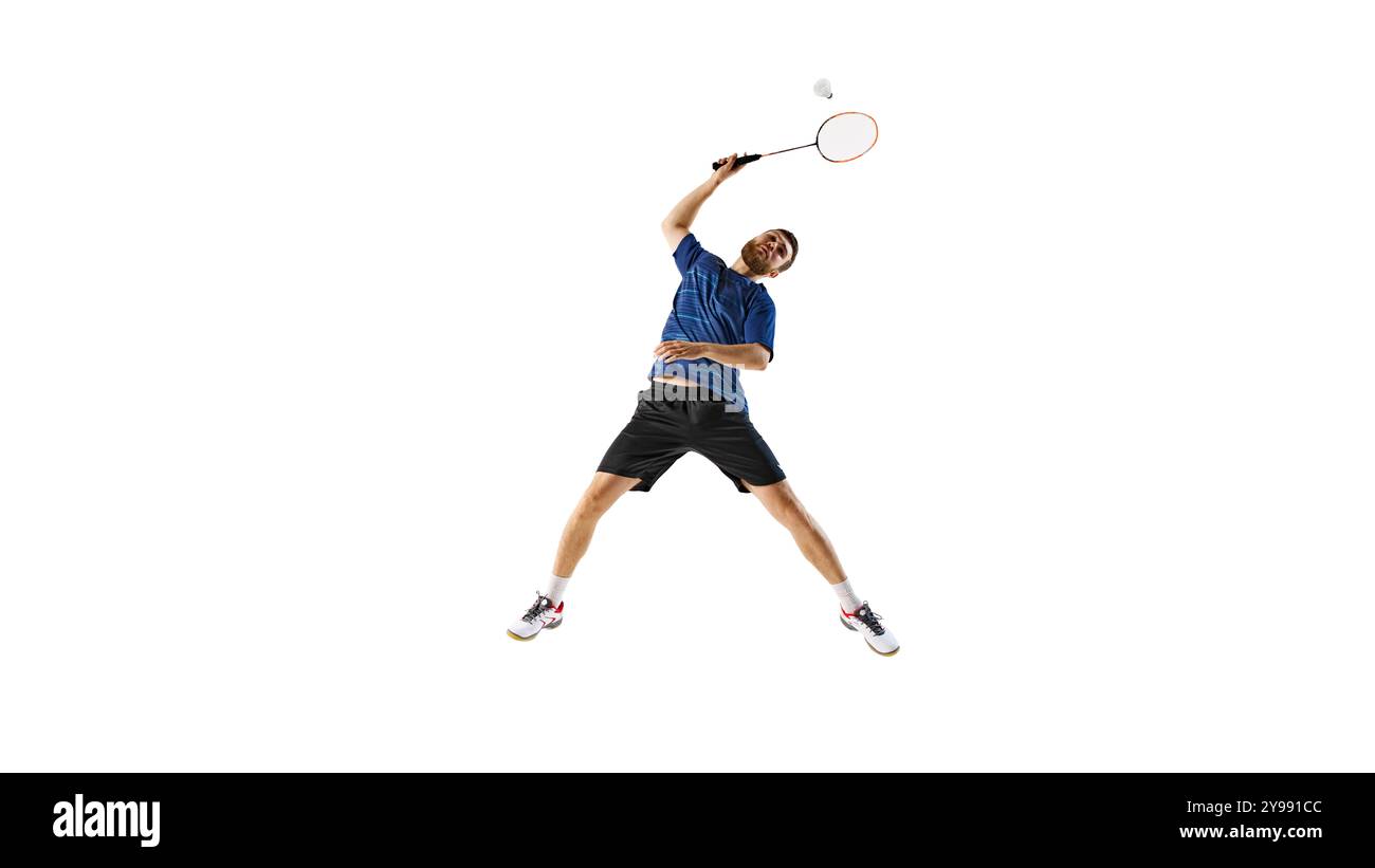 Athletic man, badminton player poised to strike, showcasing agility and ...