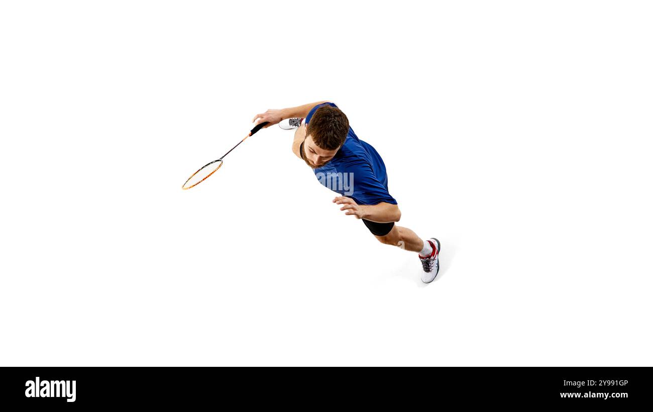 Focused badminton player stretches forward, skillfully swinging to make ...