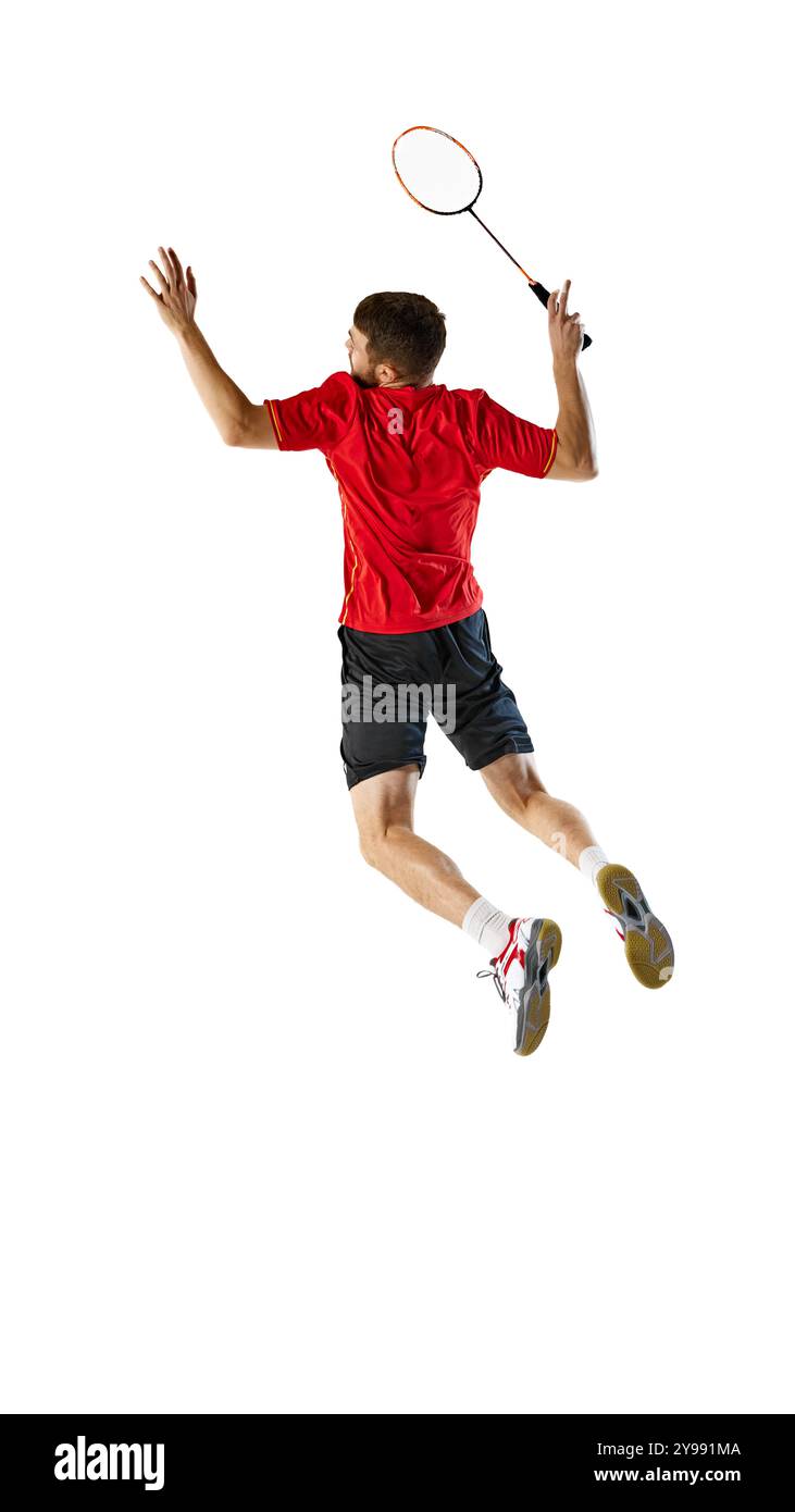 Back view of badminton player mid-air, ready to deliver powerful smash ...