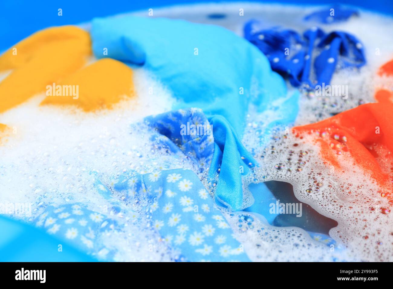Colorful clothes in suds, closeup. Hand washing laundry Stock Photo - Alamy