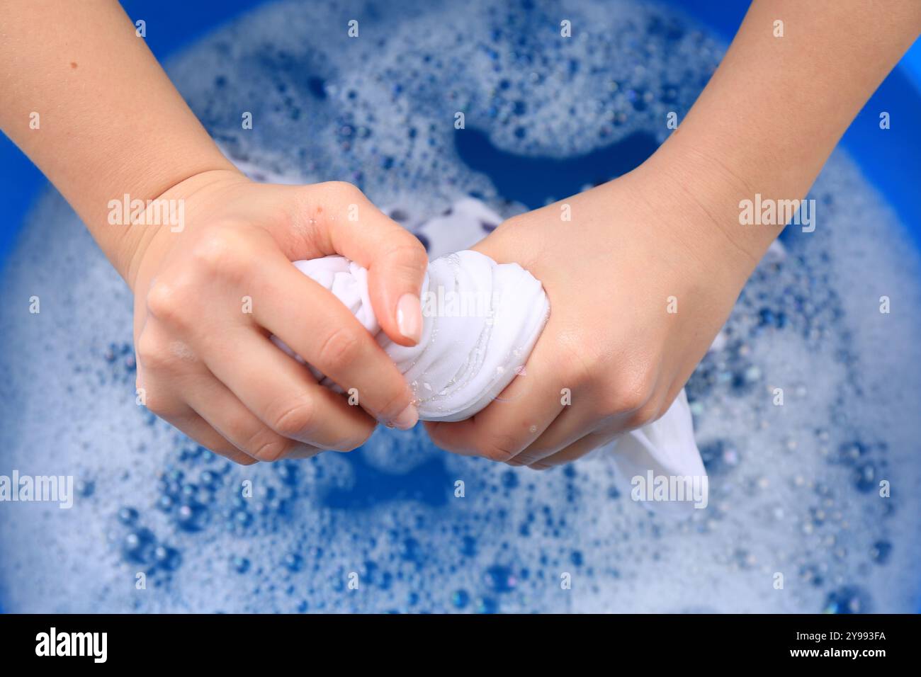 Woman wringing garment over basin, closeup. Hand washing laundry Stock ...