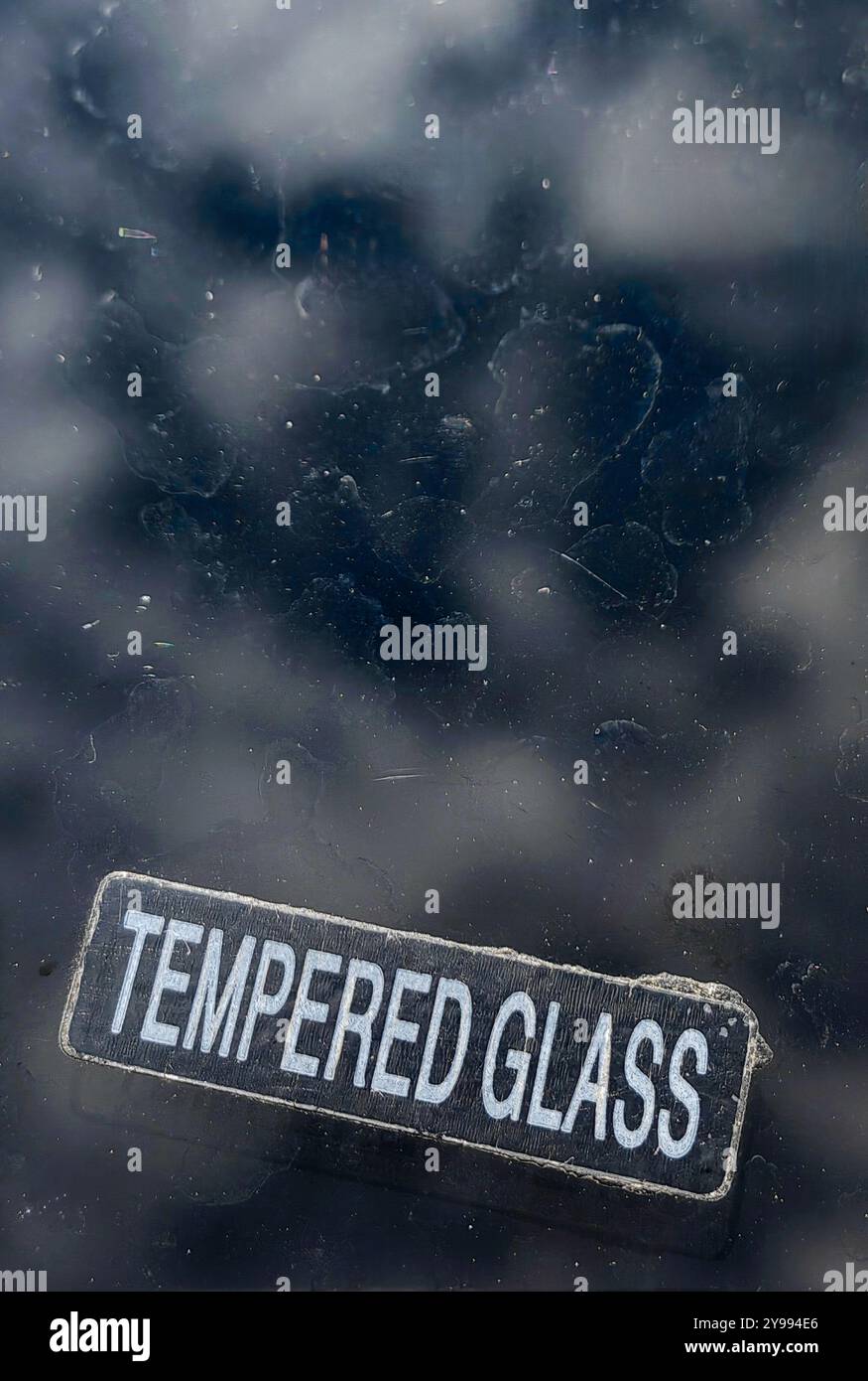 Tempered Glass Table: Sticker Detail with Dramatic Sky Reflection on a ...