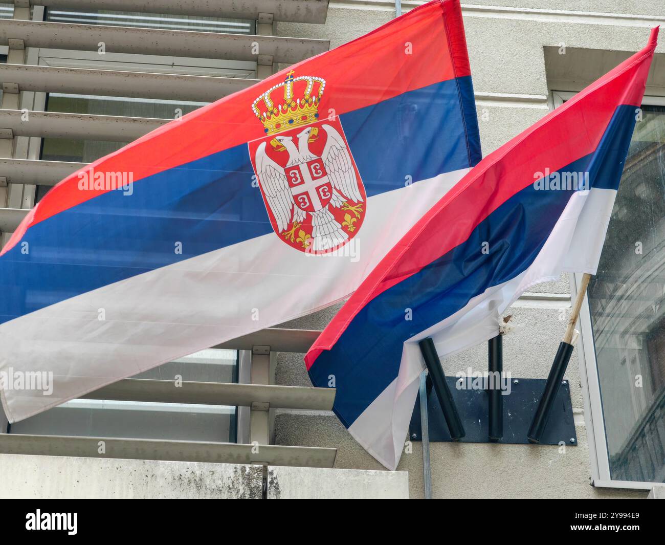 Waving Serbian Flags on the Post Building: Red, Blue, and White Symbolism Stock Photo - Alamy