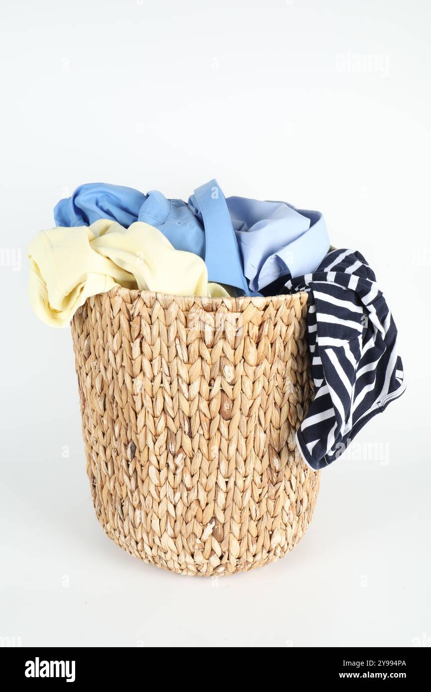 Laundry basket full of clothes isolated on white Stock Photo - Alamy