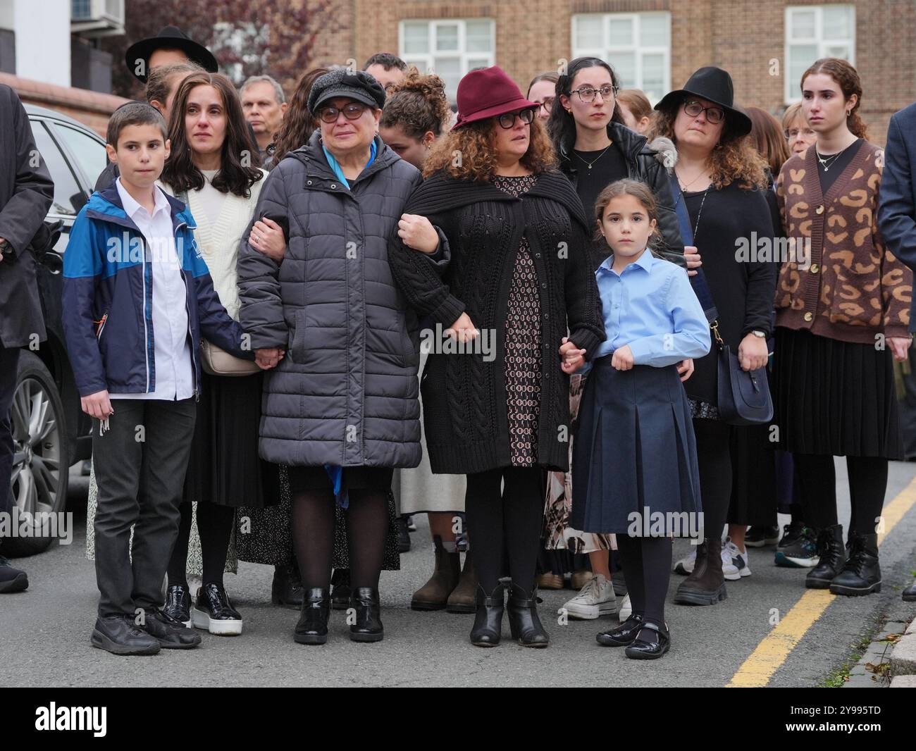 Close relatives, friends and family gather behind the funeral car ...