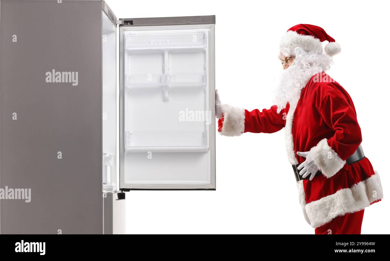 Santa Claus standing in front of an empty fridge isolated on white ...