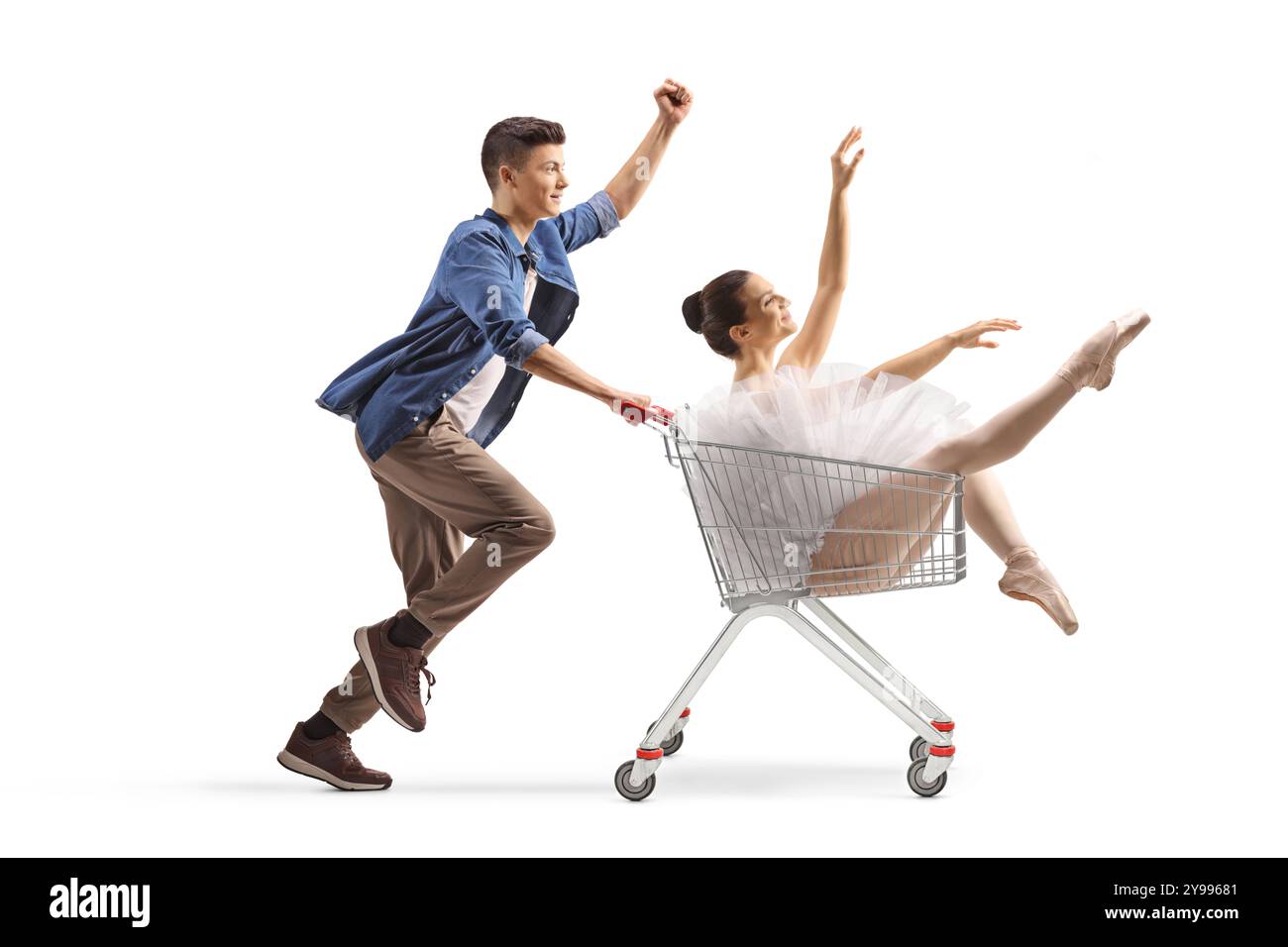 Guy running and riding a ballerina in a shopping cart isolated on white ...