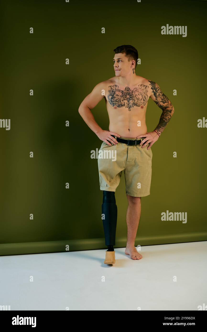 A young man with vibrant tattoos showcases his prosthetic leg while ...
