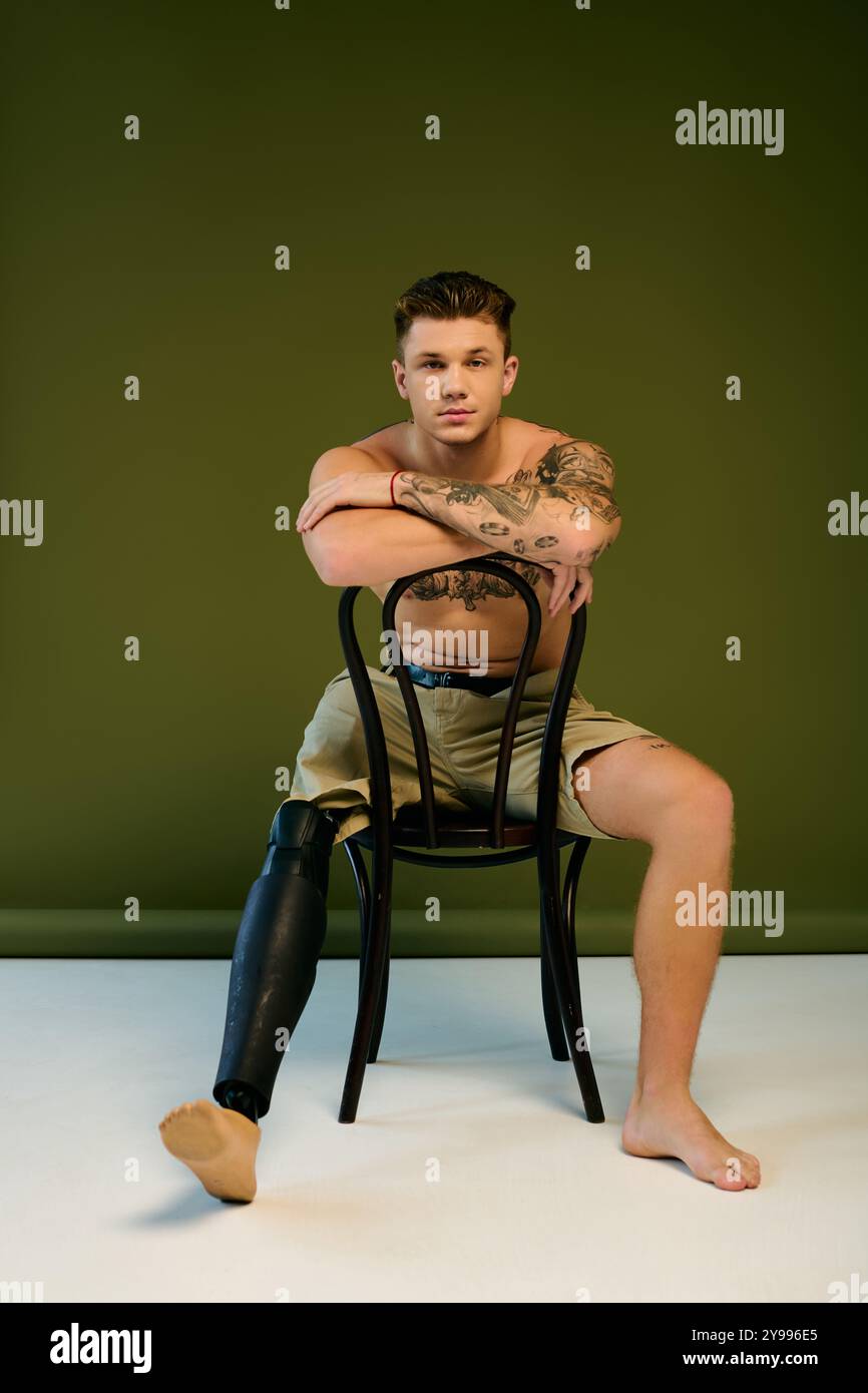 A young man with intricate tattoos and a prosthetic leg showcases his ...