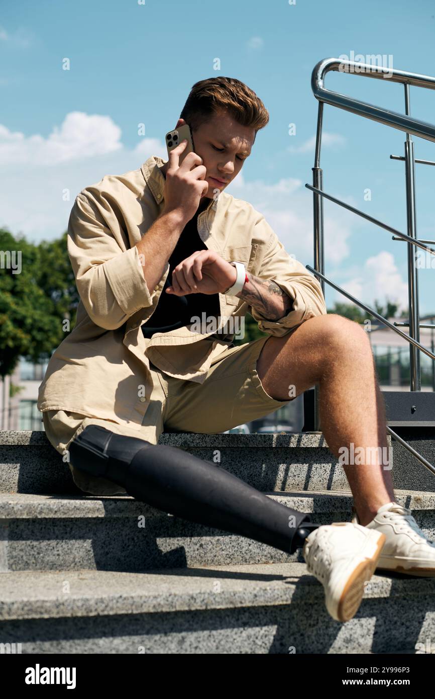 A handsome young professional with a prosthetic leg checks his watch ...