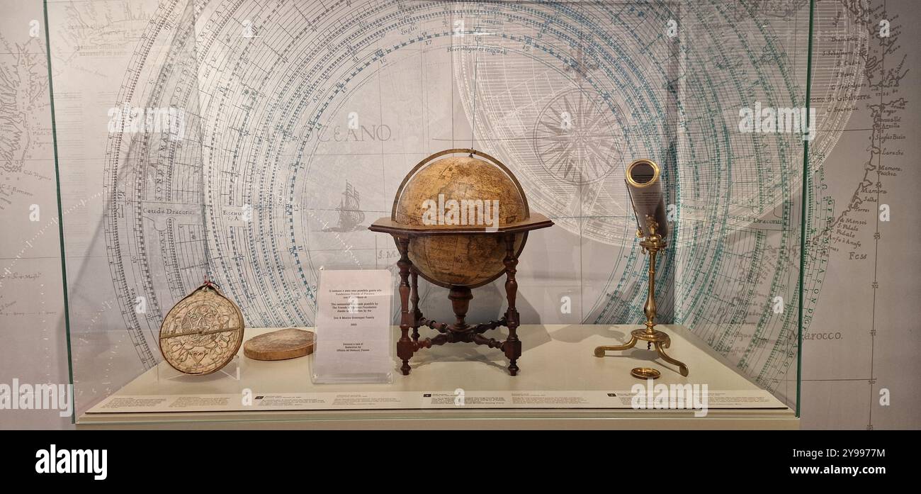 Ancient globe and telescope in a glass case in museum ¨Museo Galileo ...