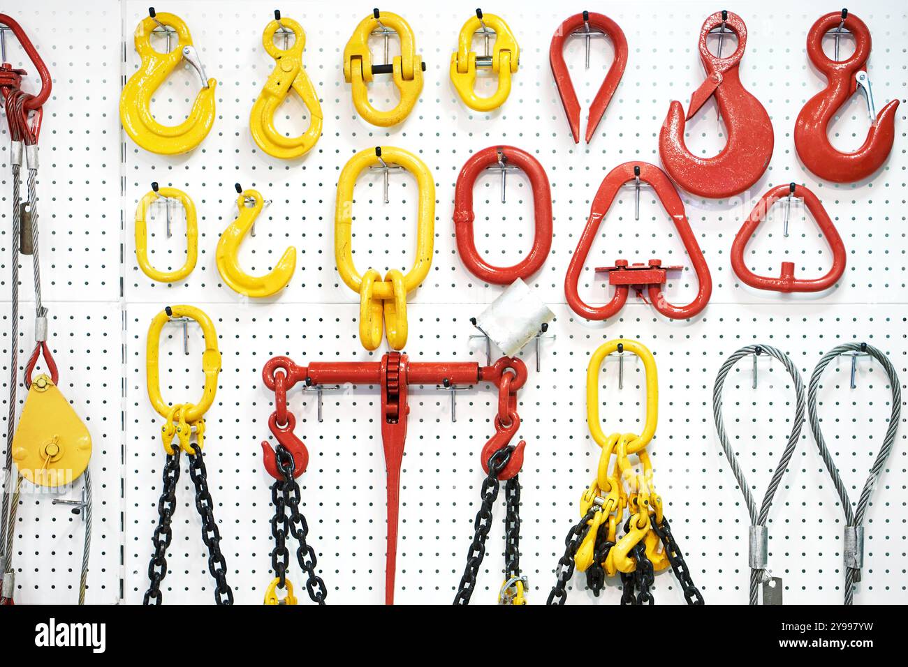 Hooks, blocks, metal cables and chains on exhibition Stock Photo - Alamy