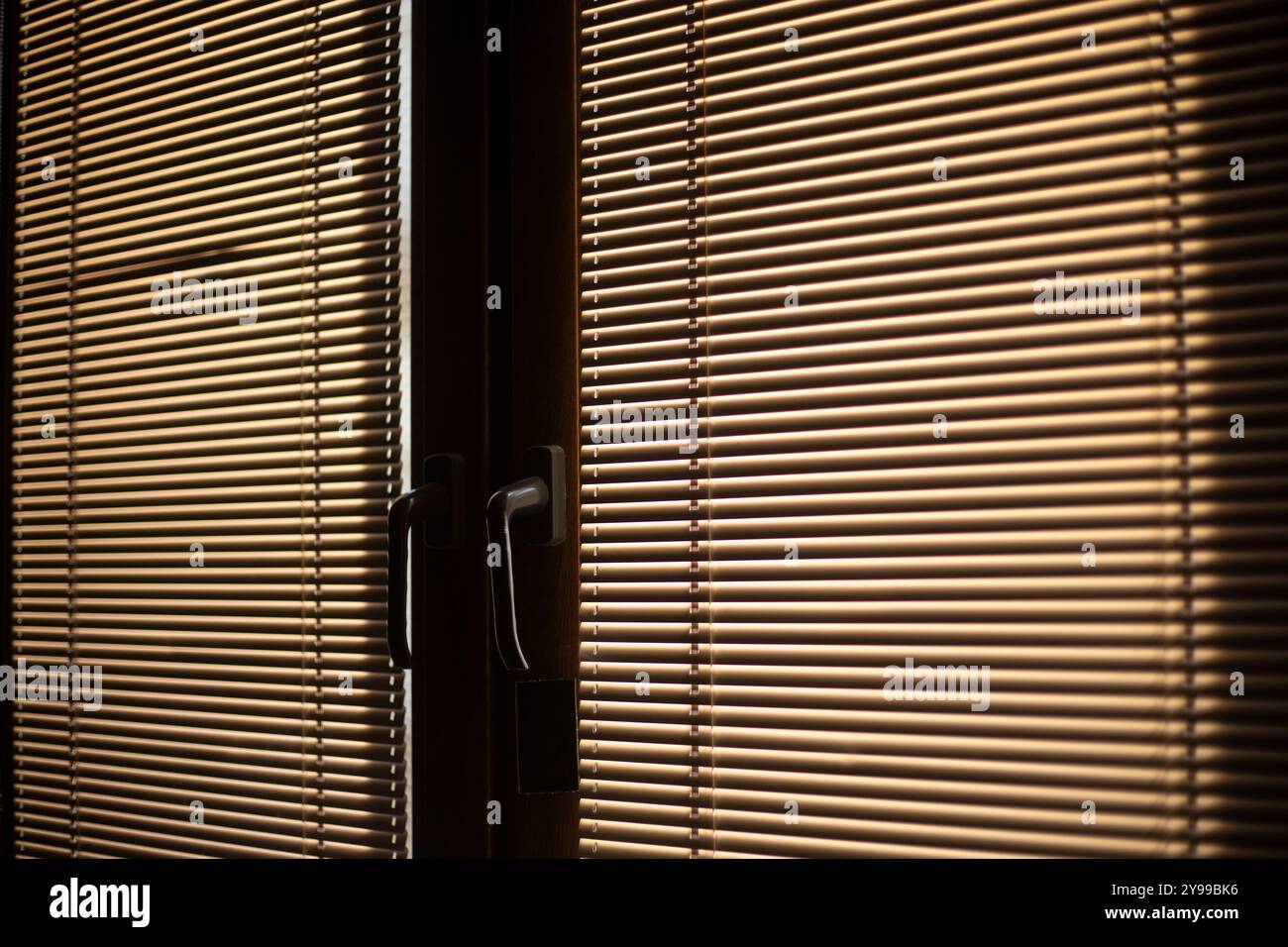 Blinds on the window. Light through the blinds. Window in the room ...