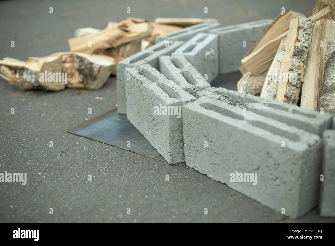A bonfire in the street. Firewood on the pavement. Concrete blocks ...
